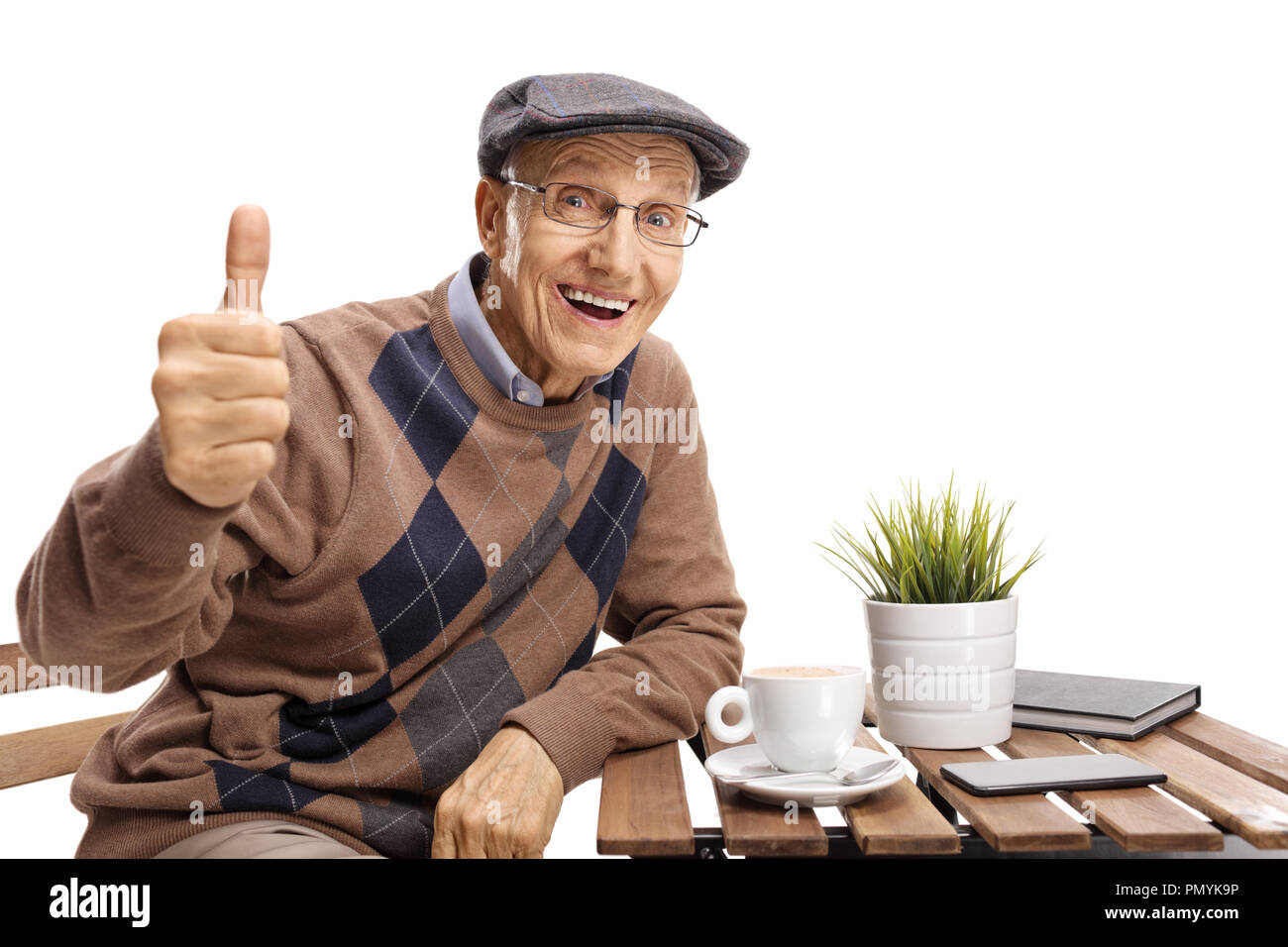 Senior sitting at a coffee table making a thumb up gesture isolated on ...