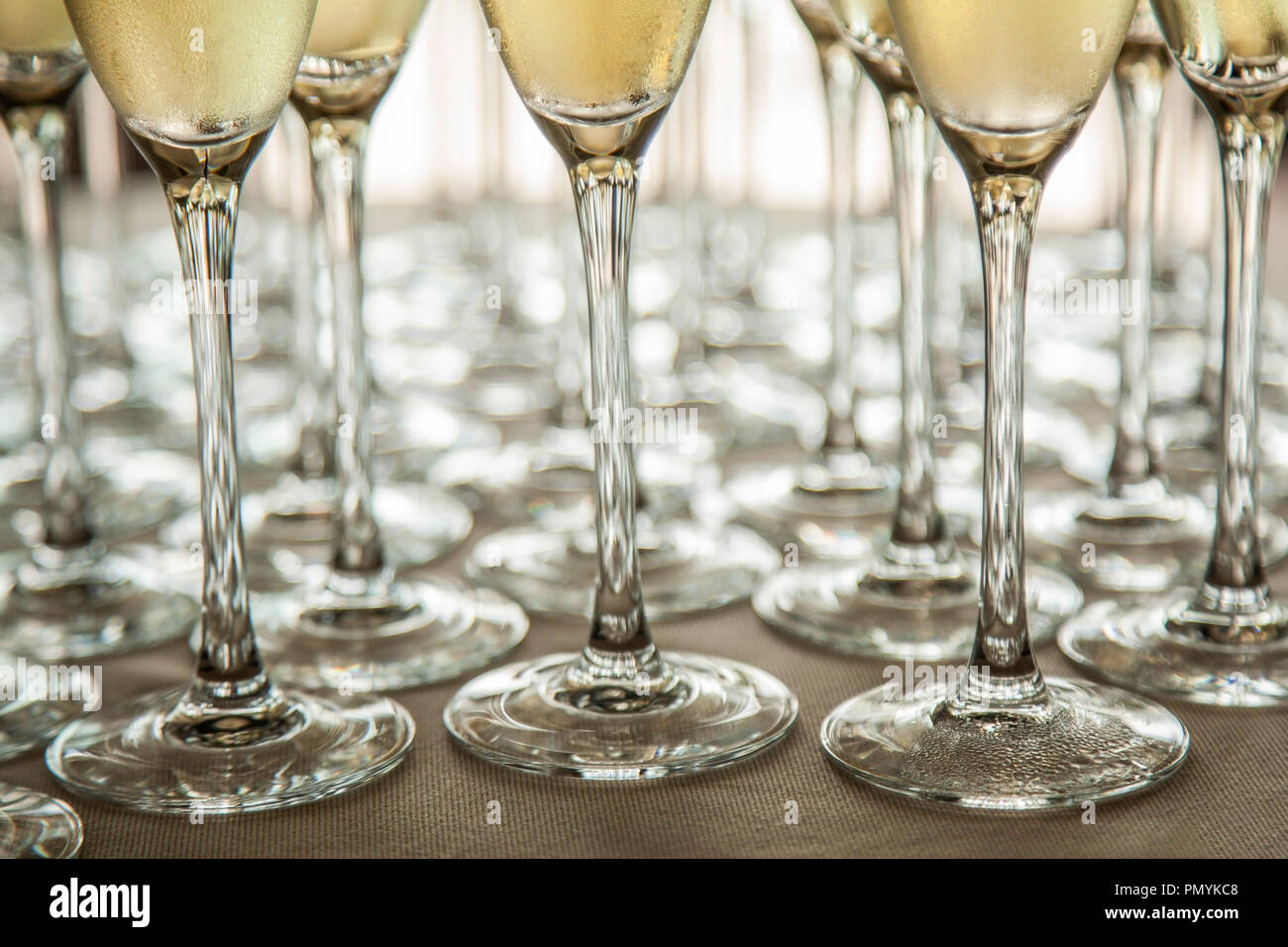 Legs of glasses with cold champagne, close-ups Stock Photo - Alamy
