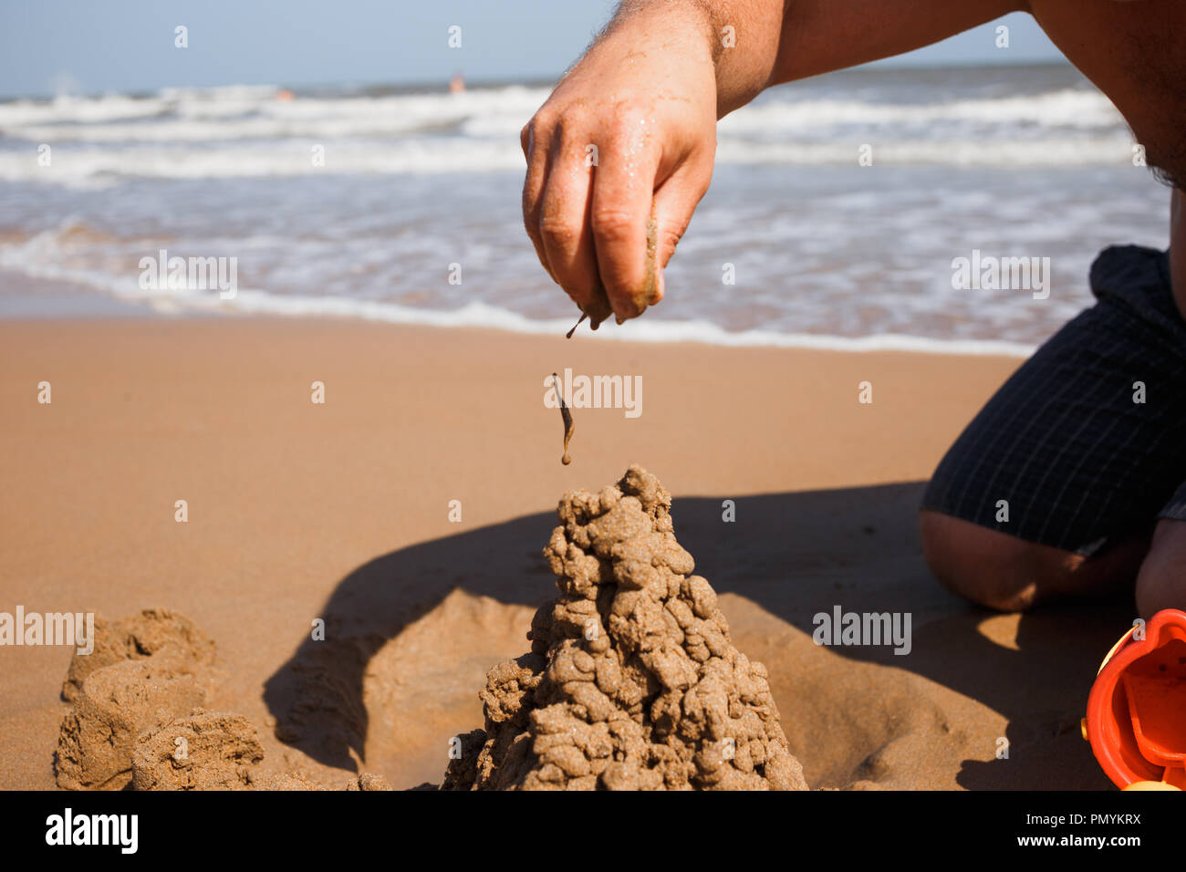 close up man's nand building sand castle at beach Stock Photo - Alamy