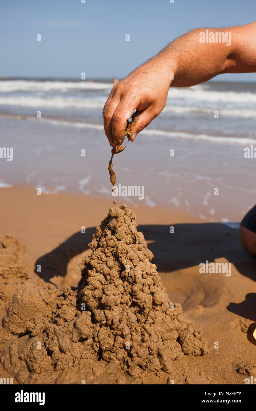 close up man's nand building sand castle at beach Stock Photo - Alamy