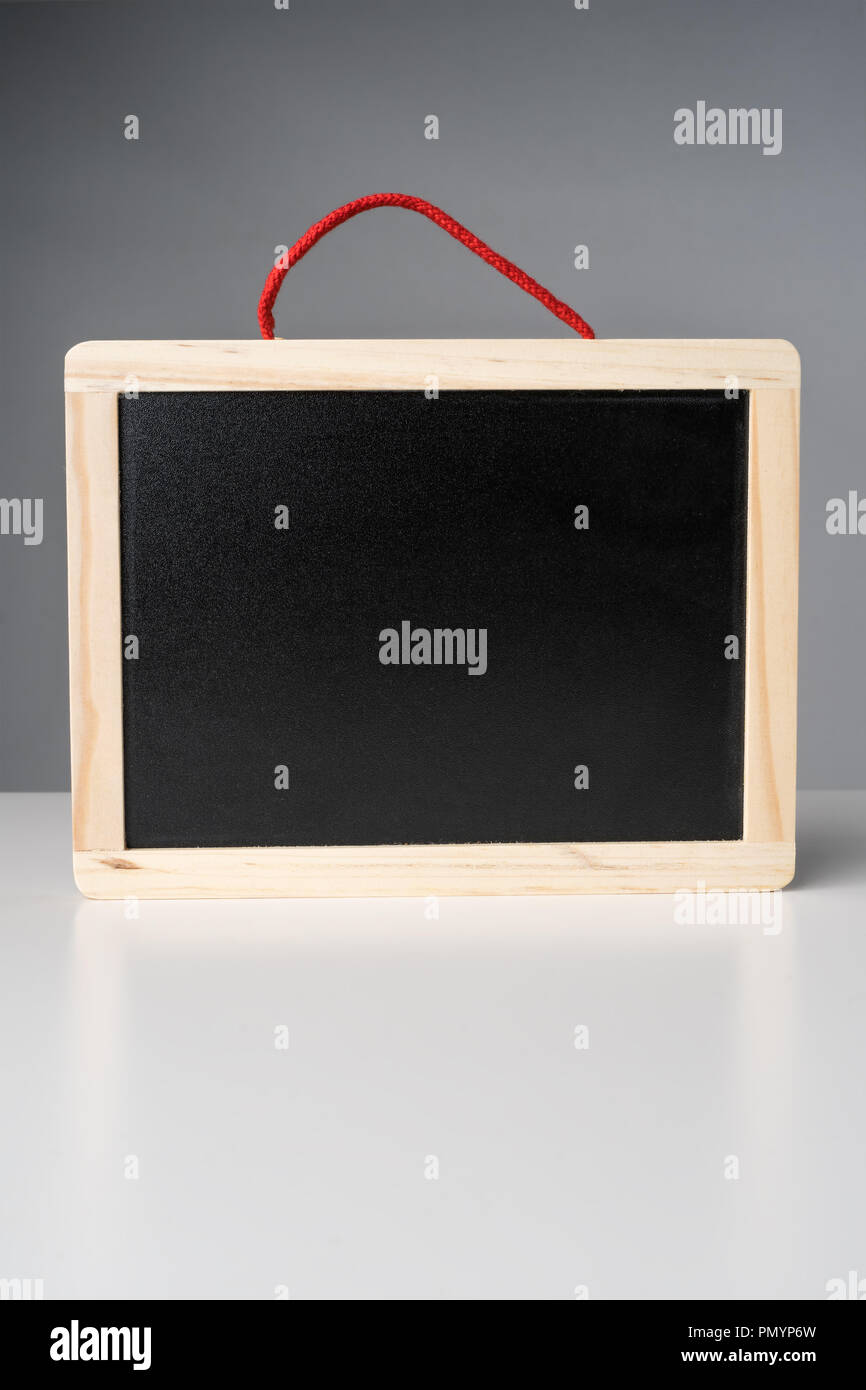 Blank school blackboard or chalkboard with wooden frame on white table ...