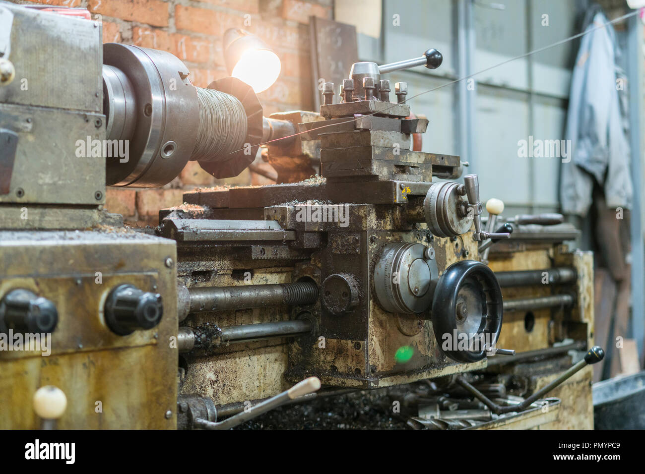 Old machinery in a factory from the mid-20th c. working machine-tool ...
