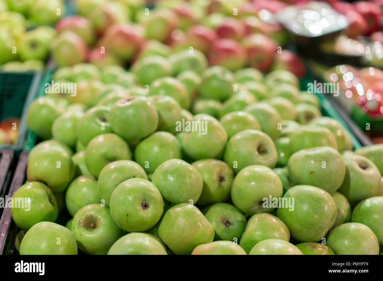 Green apples in a box in the store. green apples in boxes on market ...