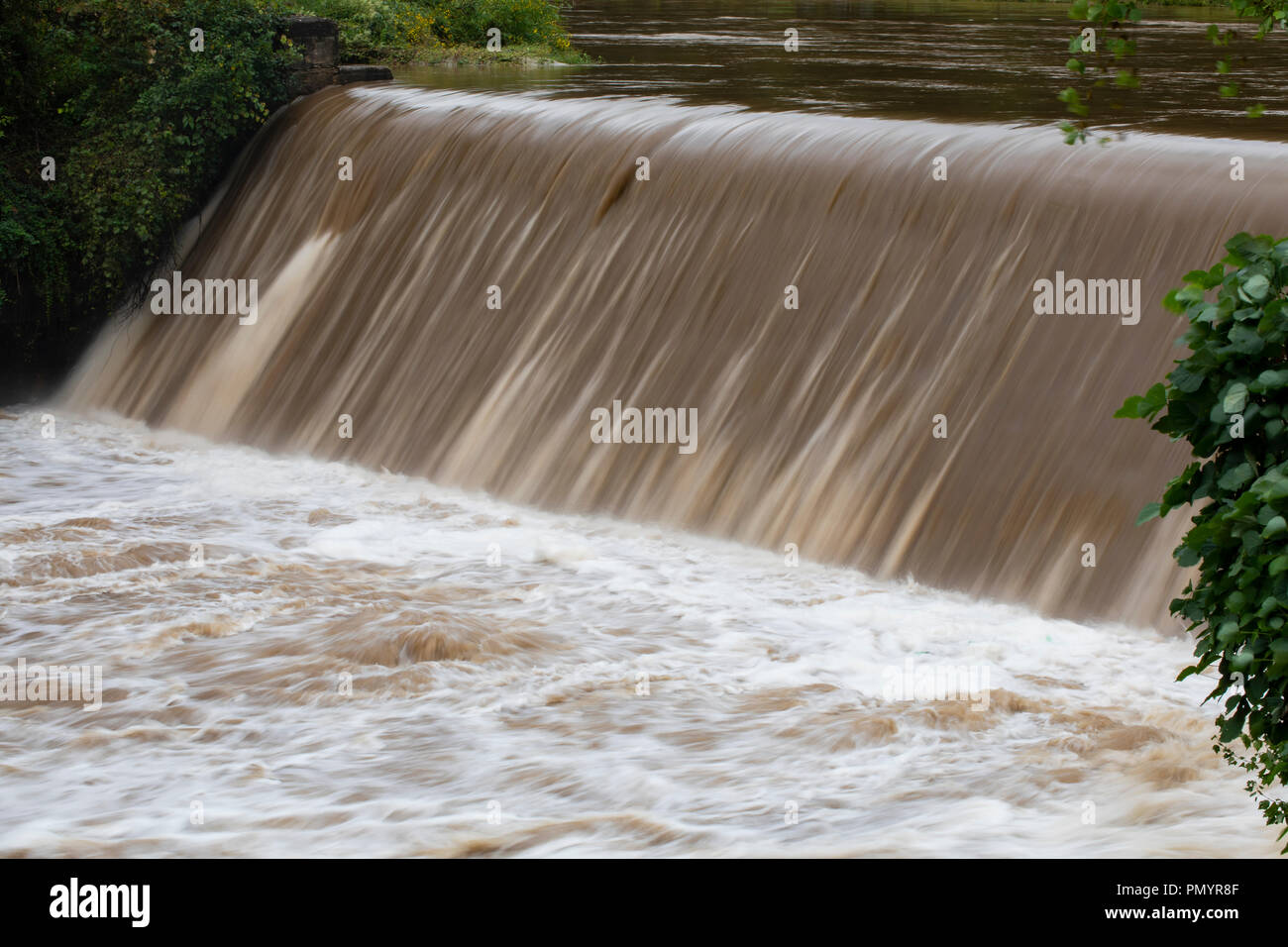 Brown rain runoff from Hurricane Florence rushes over the spillway on ...