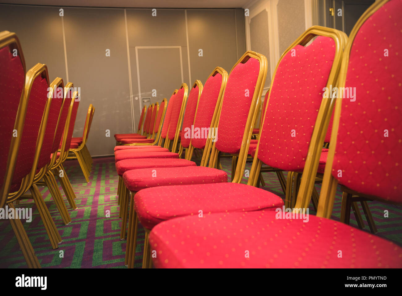 Row of red soft chairs in a conference room with a carpet Stock Photo ...