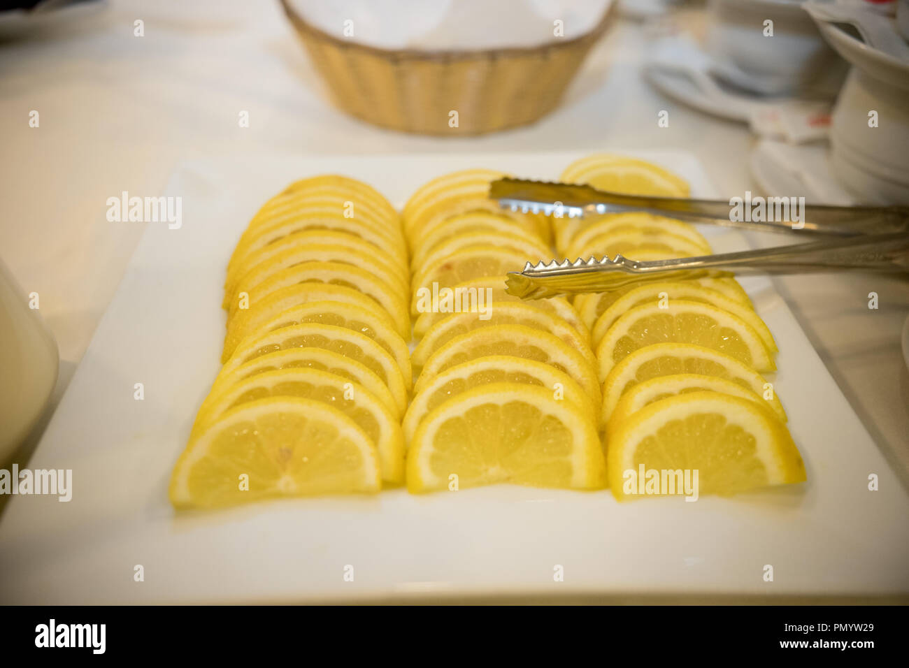 Lemon slices in a square plate on the dining table Stock Photo - Alamy