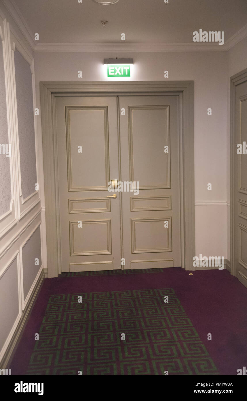 Emergency exit door in a restaurant with a neon sign Stock Photo - Alamy