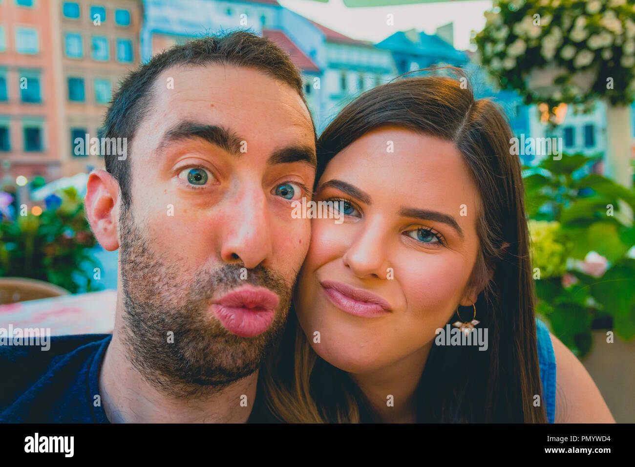 Happy Young Couple Taking A Selfie With A Smartphone Or Camera In The