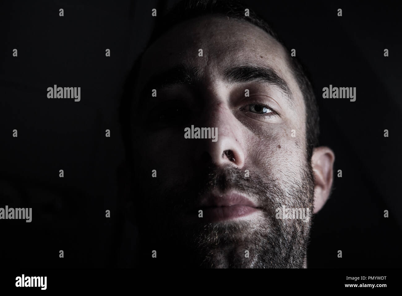 Man looking down shadow face close up hi-res stock photography and ...