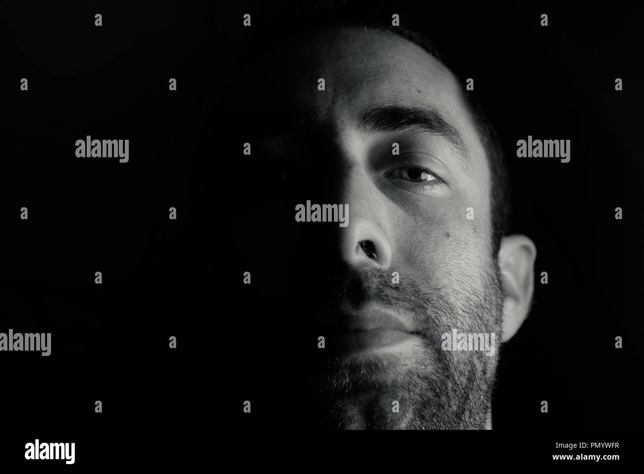 Man looking down shadow face close up hi-res stock photography and ...