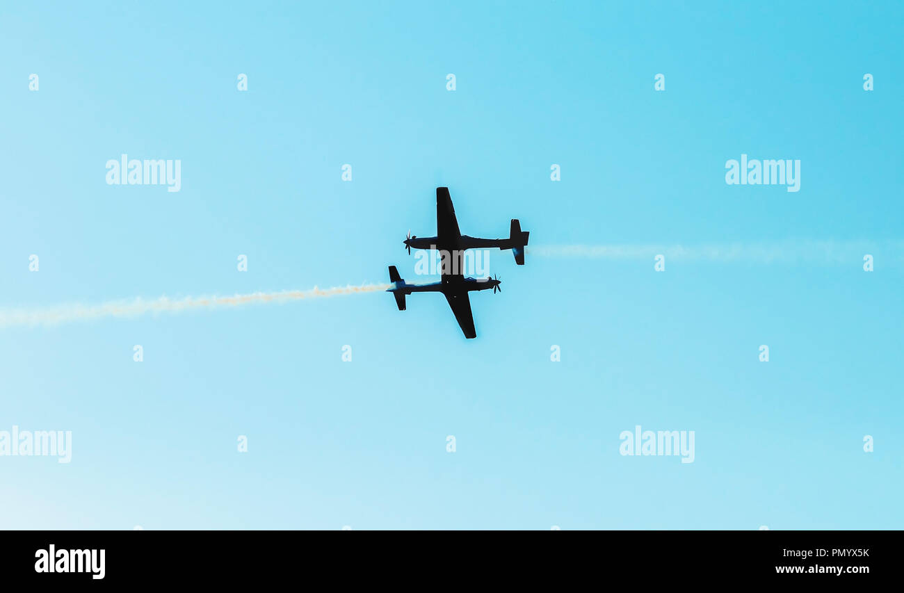 Silhouette of two airplanes crossing each other's path almost hitting ...