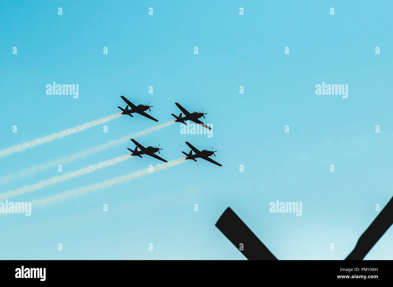 Squad of four military airplanes flying together leaving a smoke trail ...