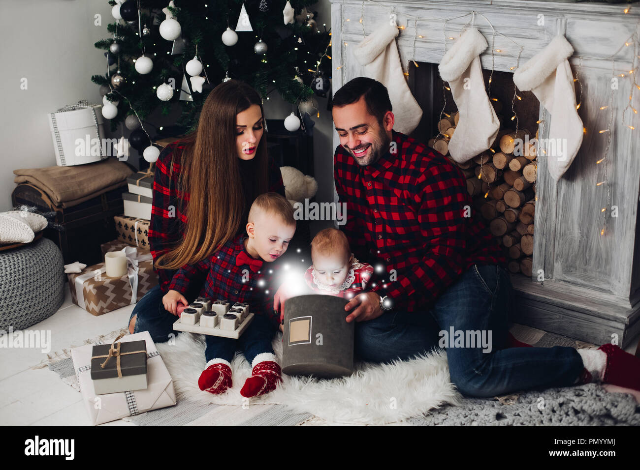Happy family opening christmas presents with children Stock Photo - Alamy