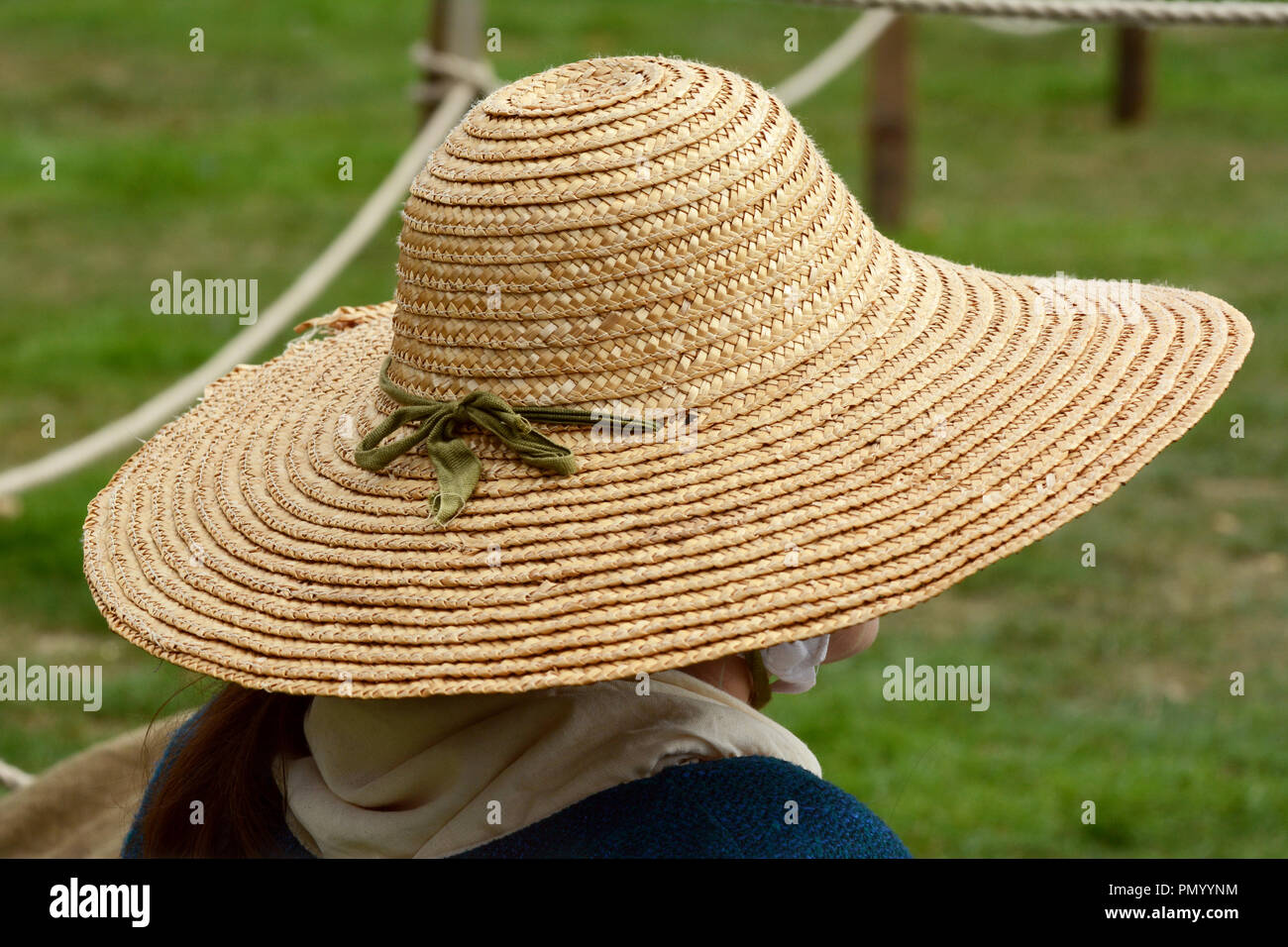 Woman wearing a traditional straw hat, her face hidden at a Medieval ...