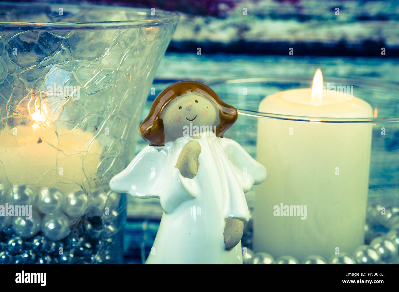 beautiful angel figure and burning candles background Stock Photo - Alamy