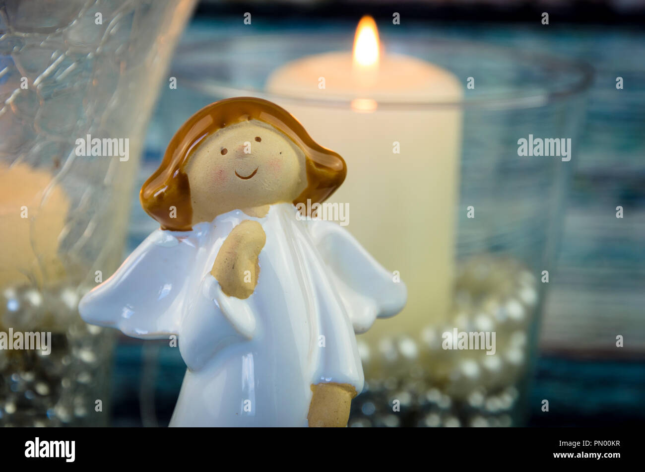 beautiful angel figure and burning candles background Stock Photo - Alamy