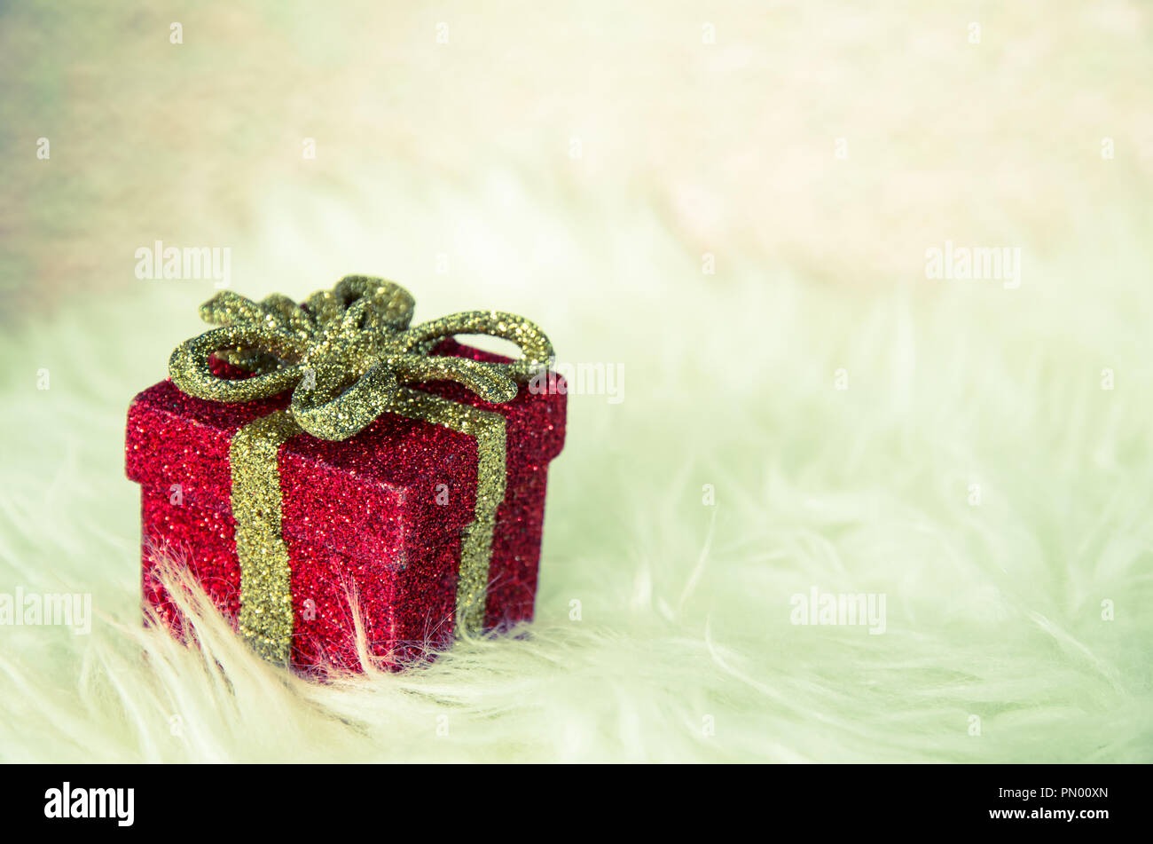 red christmas present box with golden ribbon against white background ...