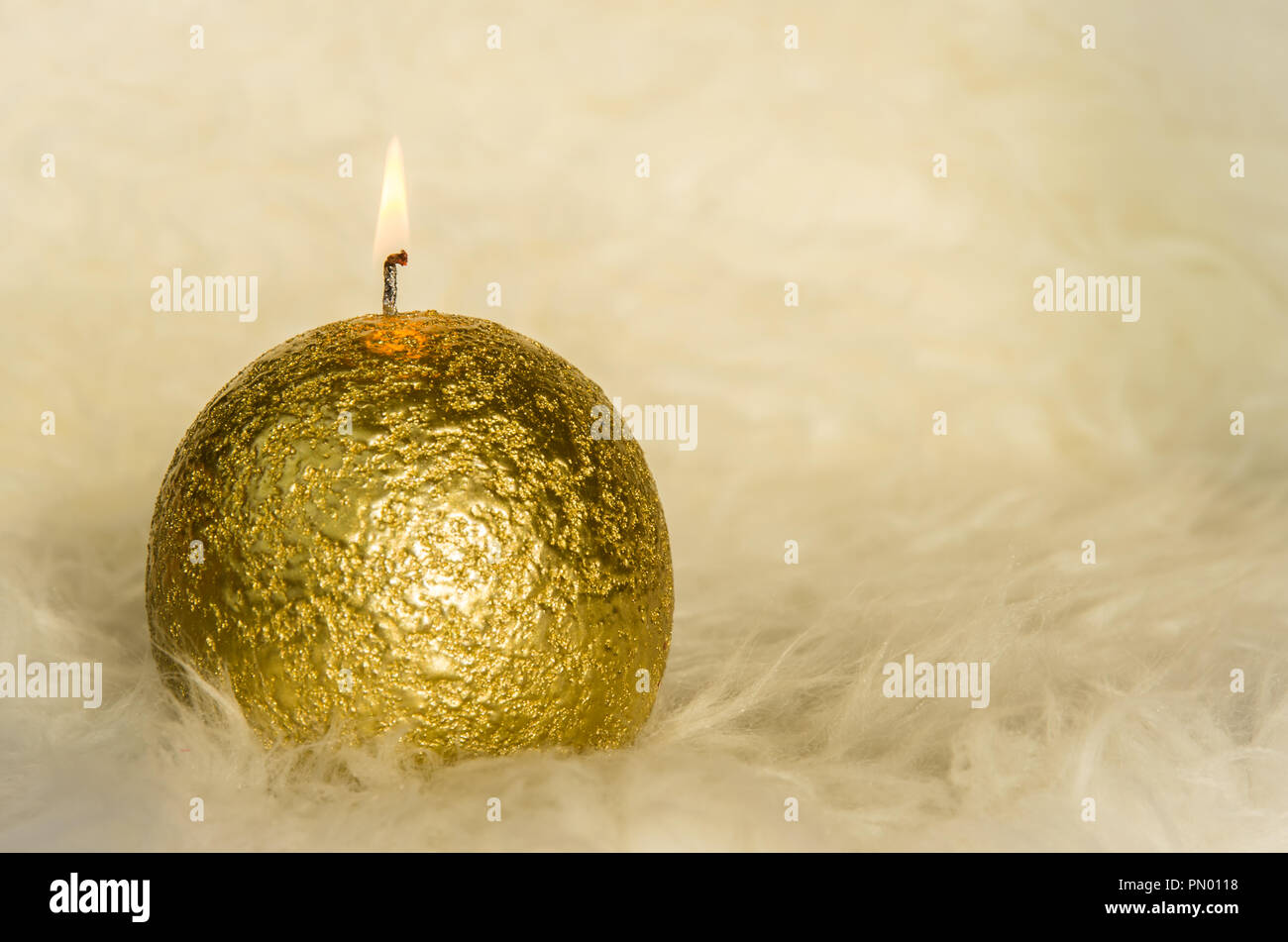 one golden burning candle against white background Stock Photo - Alamy
