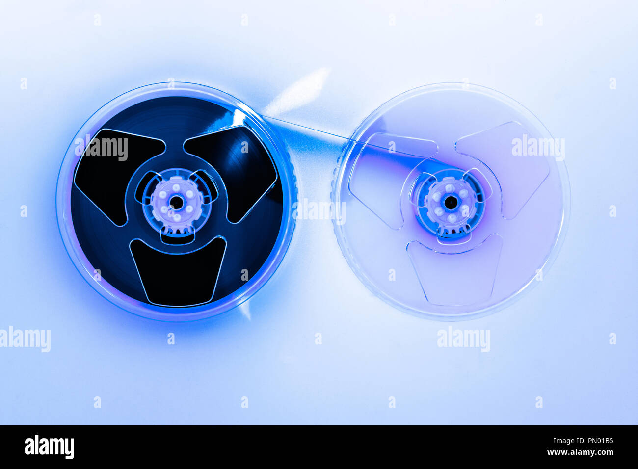 Abstract composition of video home system VHS tape reels illuminated ...