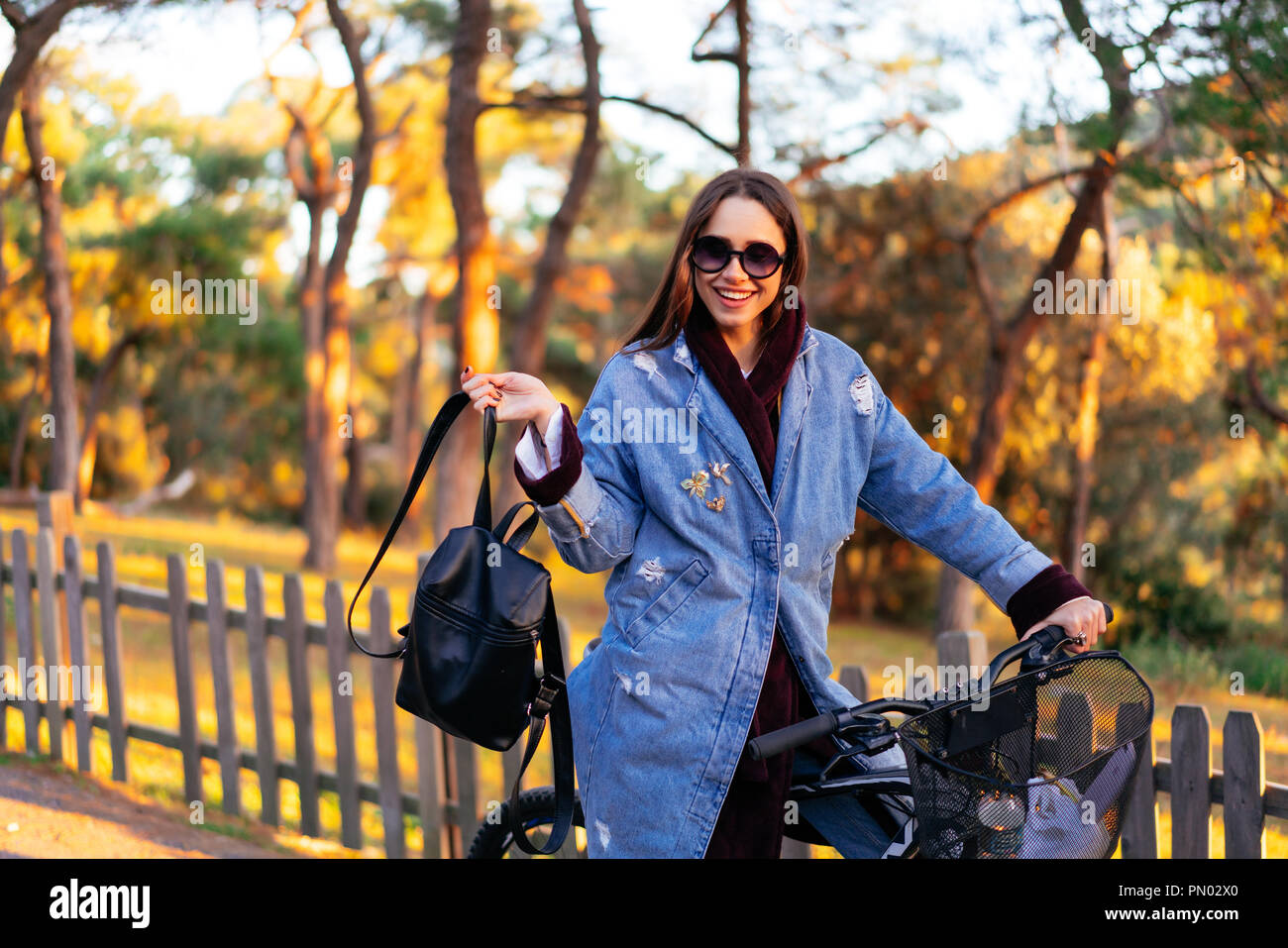 Beautiful young girl on a bicycle posing at the camera Stock Photo - Alamy