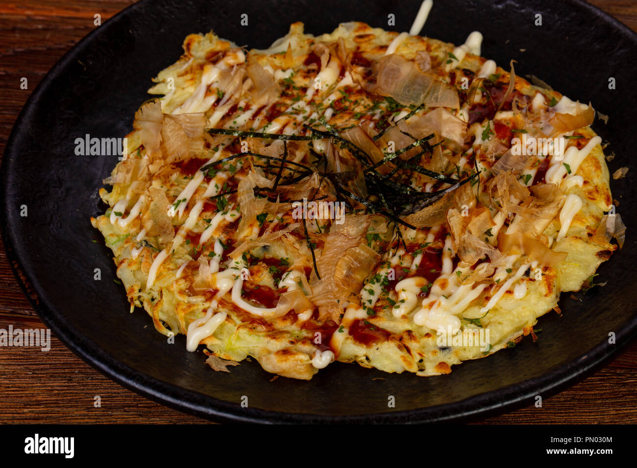 Japanese pizza with seafood and fish Stock Photo - Alamy