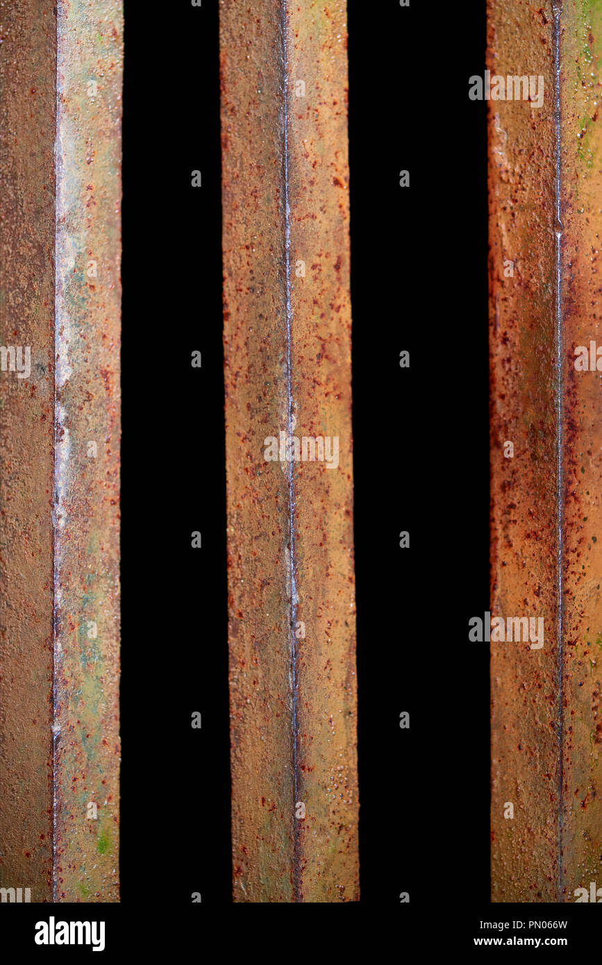 close up view of rust fence with black background behind Stock Photo ...
