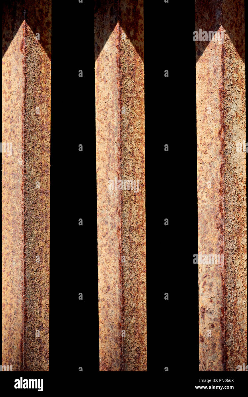 close up view of rust fence with black background behind Stock Photo ...
