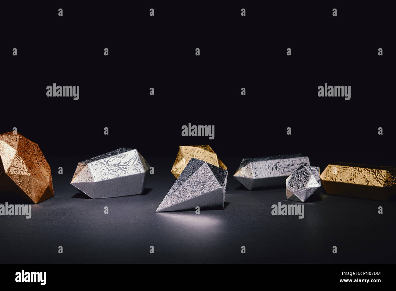shiny pieces of silver and gold on black background Stock Photo - Alamy