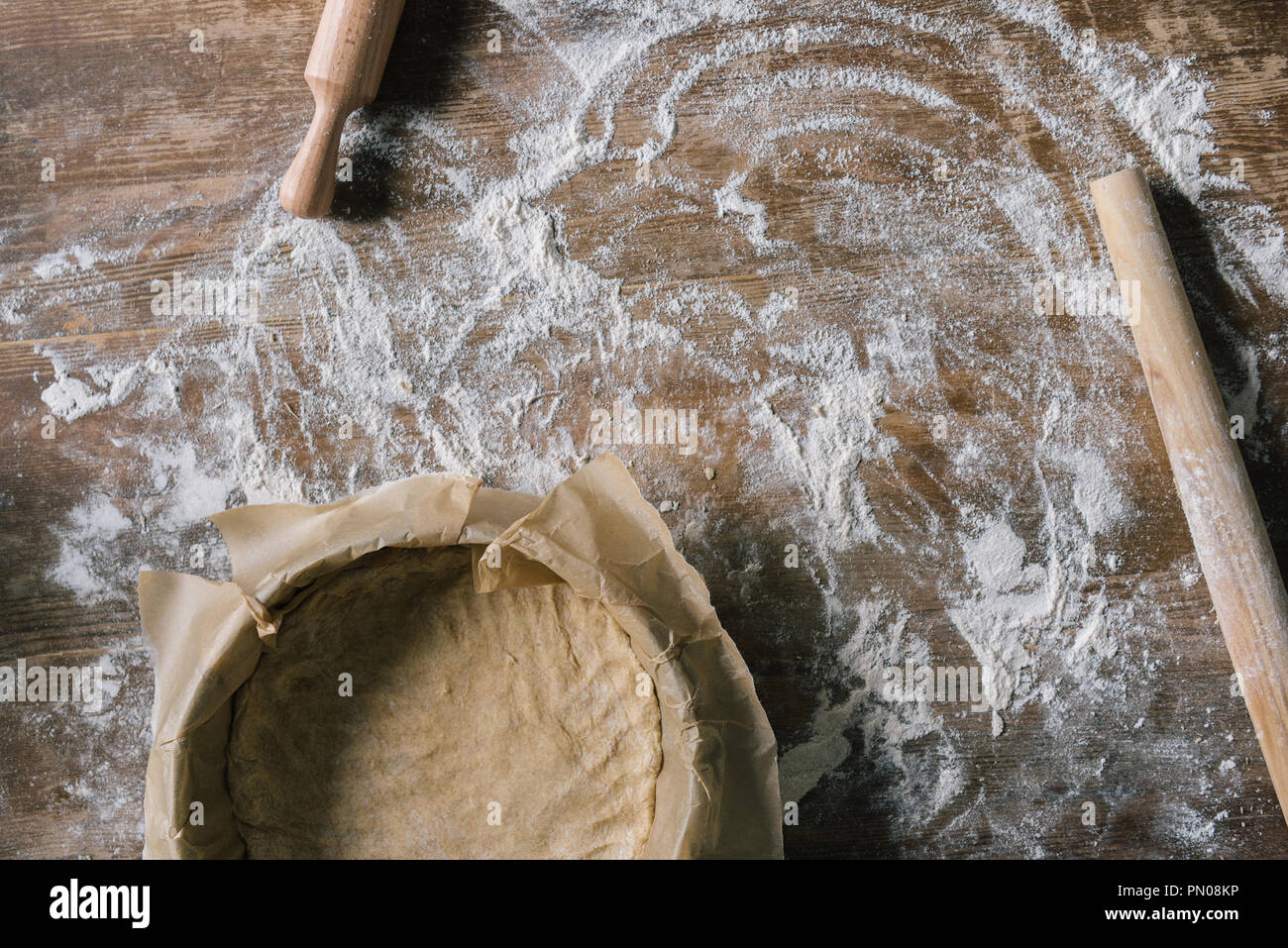 baking tray with parchment paper on rustic wooden table covered with ...