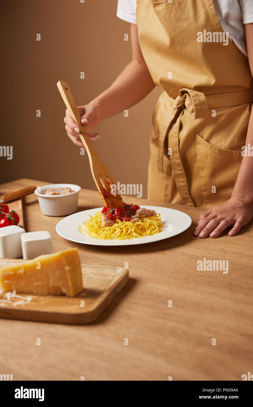 Woman putting apron on hi-res stock photography and images - Alamy