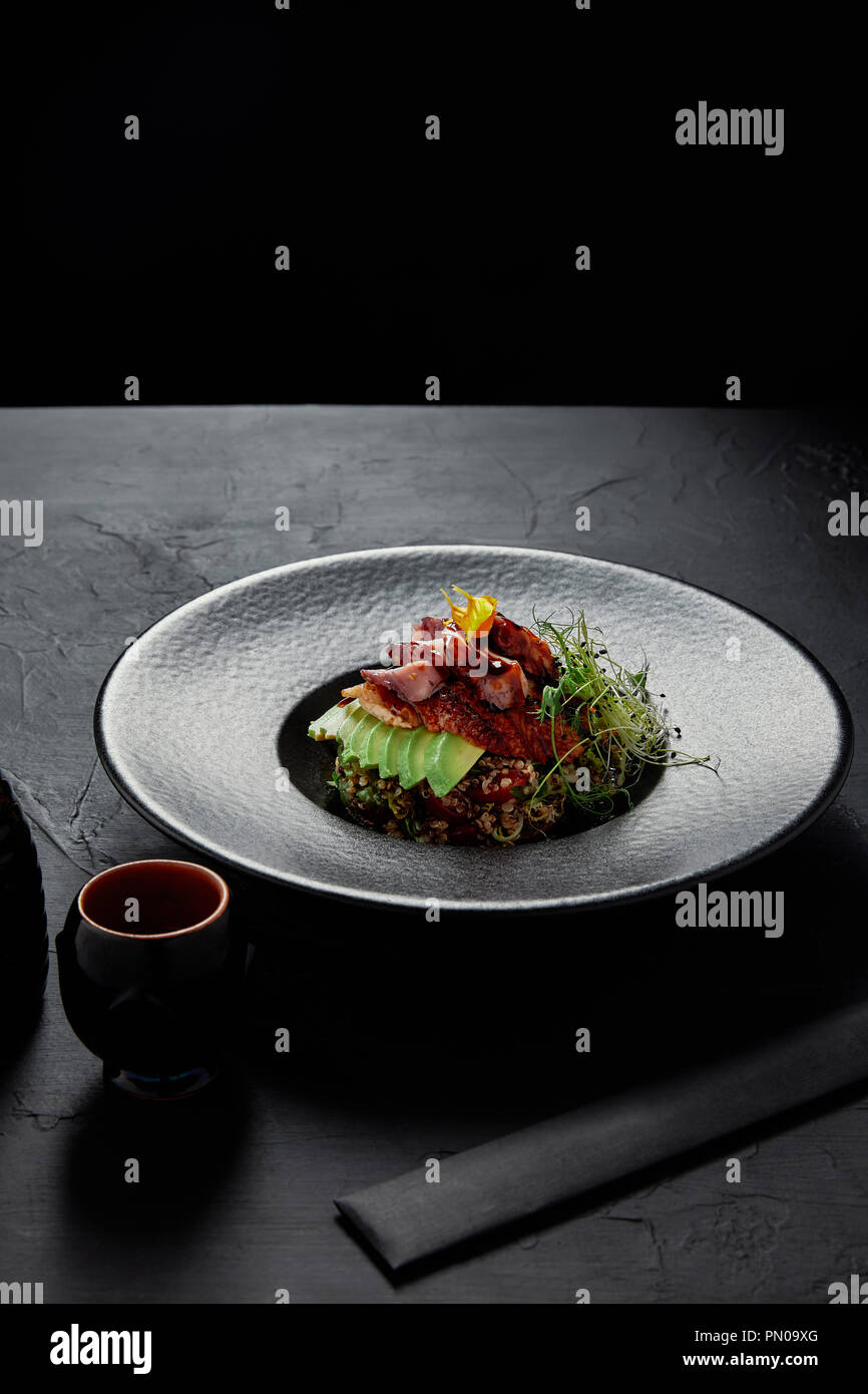 delicious Japanese Ceviche with seafood, avocado and herbs on black ...