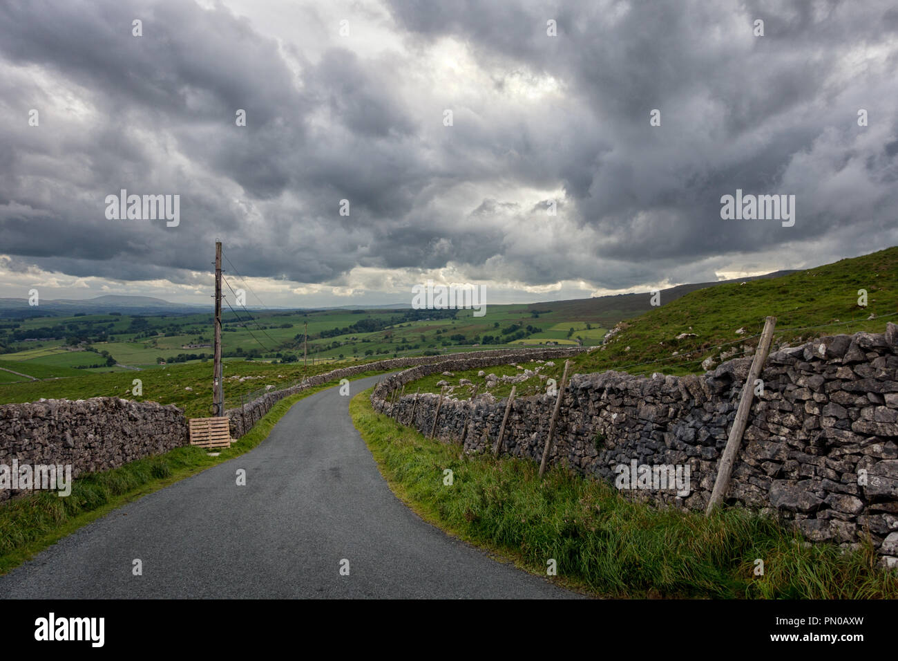 Moody stormy sky over a Malham Moor landscape looking down the steep ...