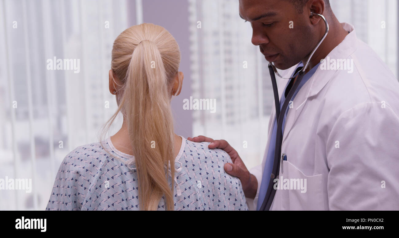 Black doctor talking to patient Stock Photo - Alamy