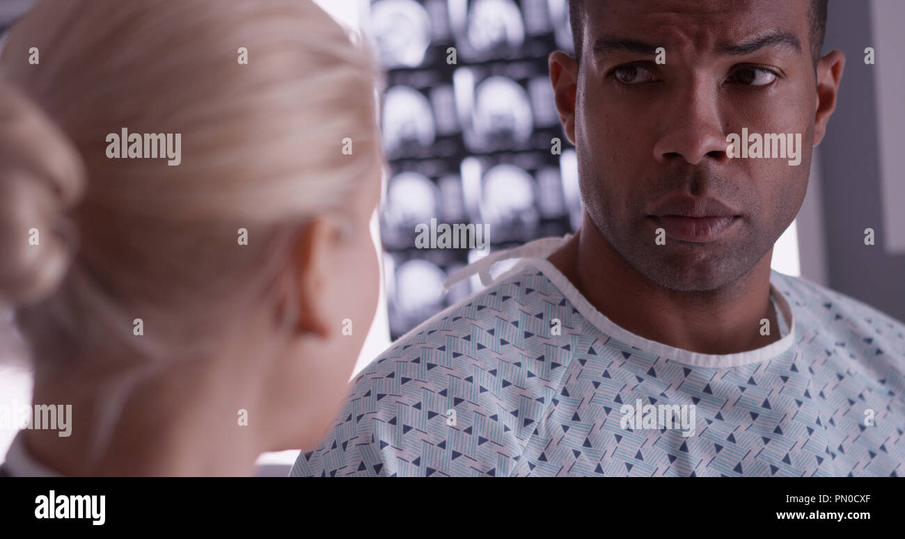 Doctor delivering bad news to black patient Stock Photo - Alamy