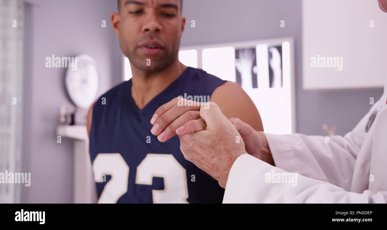 College basketball player with sports injury being examined by doctor ...