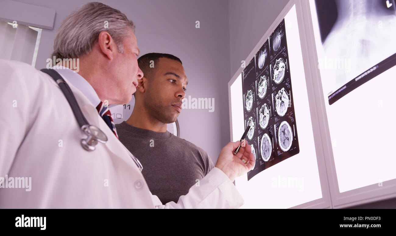 Mid aged medical doctor reviewing hi-res stock photography and images ...