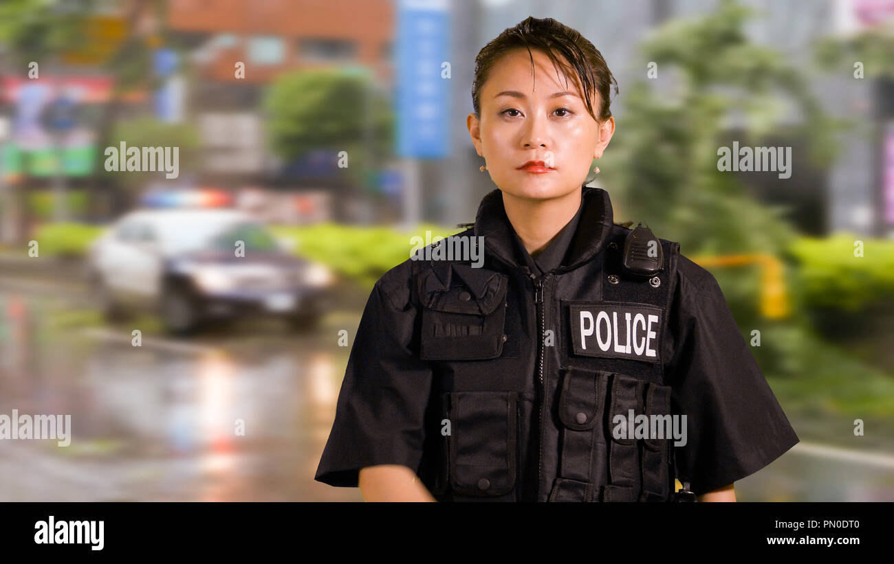 Asian American Woman Police Officer at Crime scene looking Serious ...