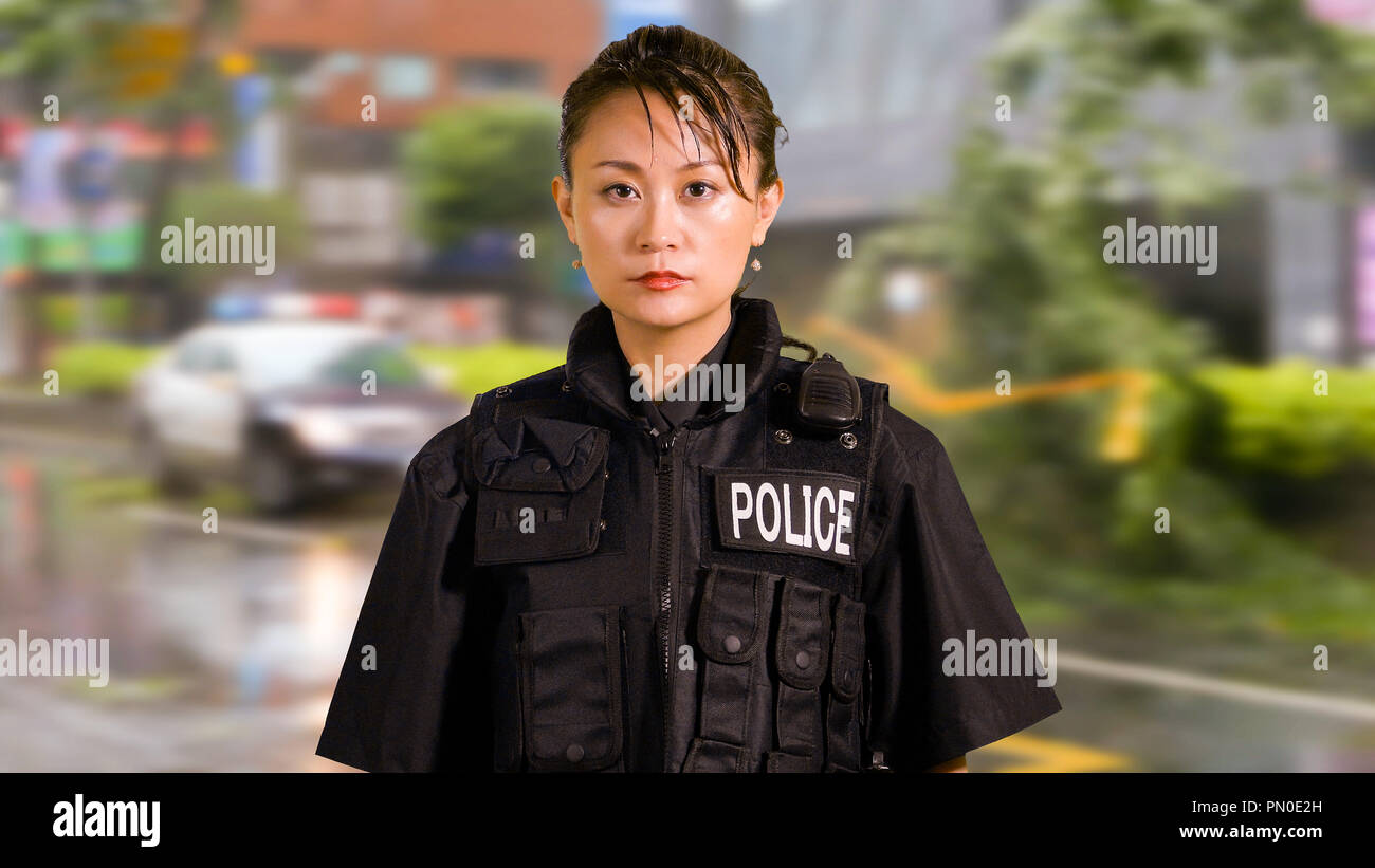 Enviromental portrait of Asian American Police Officer at Crime scene ...