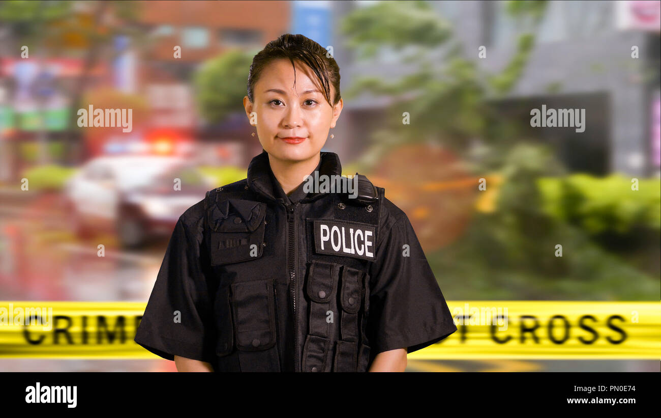 Asian American Woman Police Officer Smiles at Camera Stock Photo - Alamy