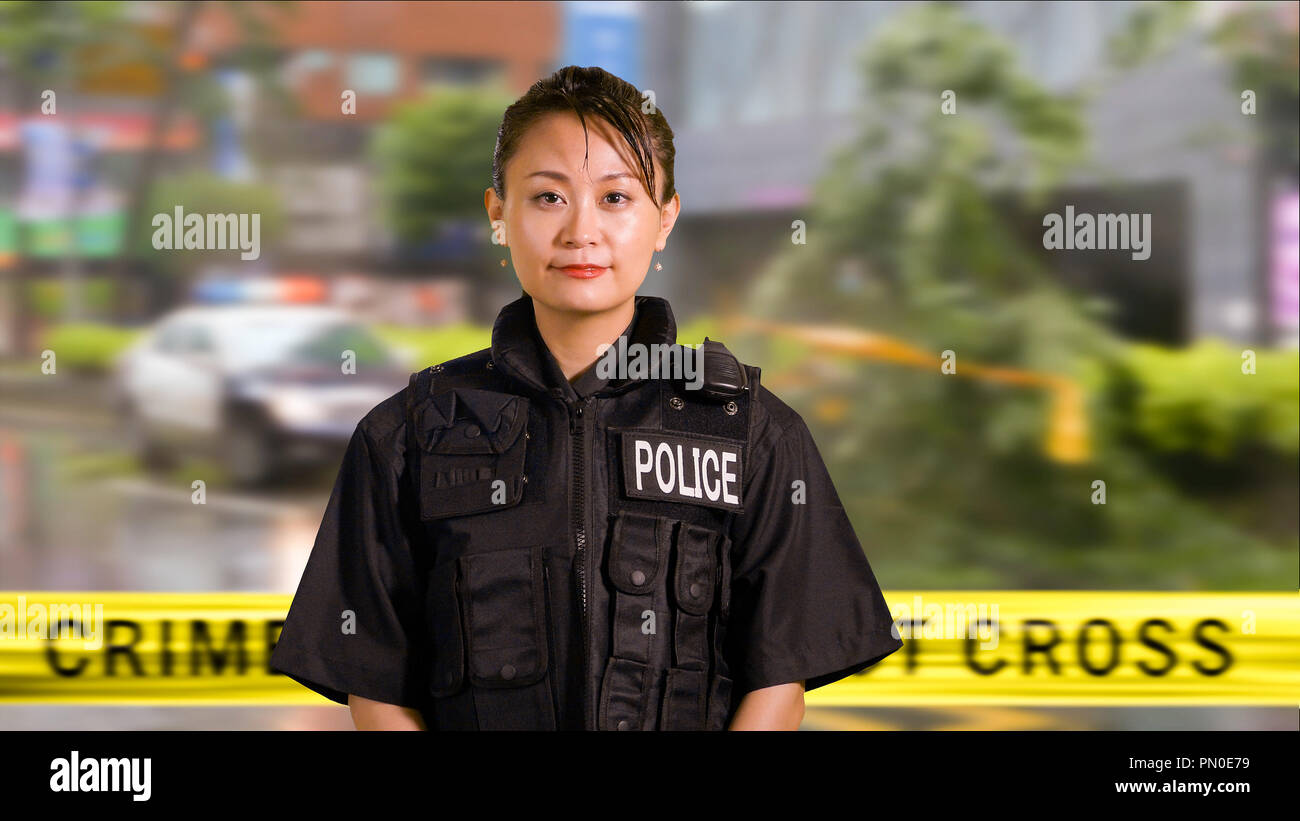 Asian American Woman Police Officer Smiles at Camera Stock Photo - Alamy