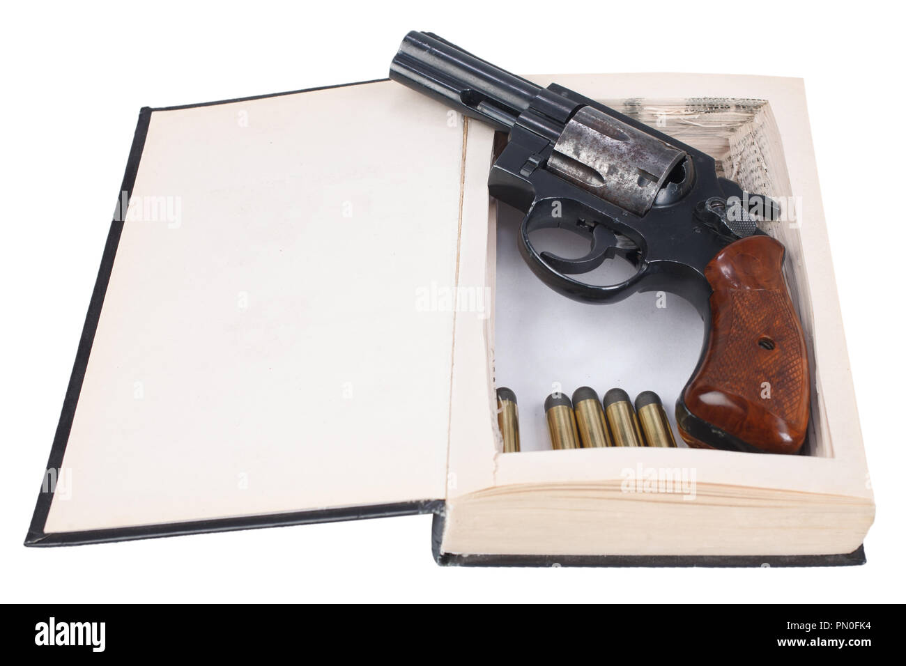 .38 caliber revolver gun with cartridges hidden in a book isolated on ...