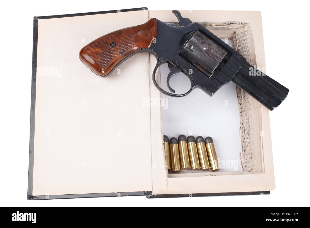 .38 caliber revolver gun with cartridges hidden in a book isolated on ...