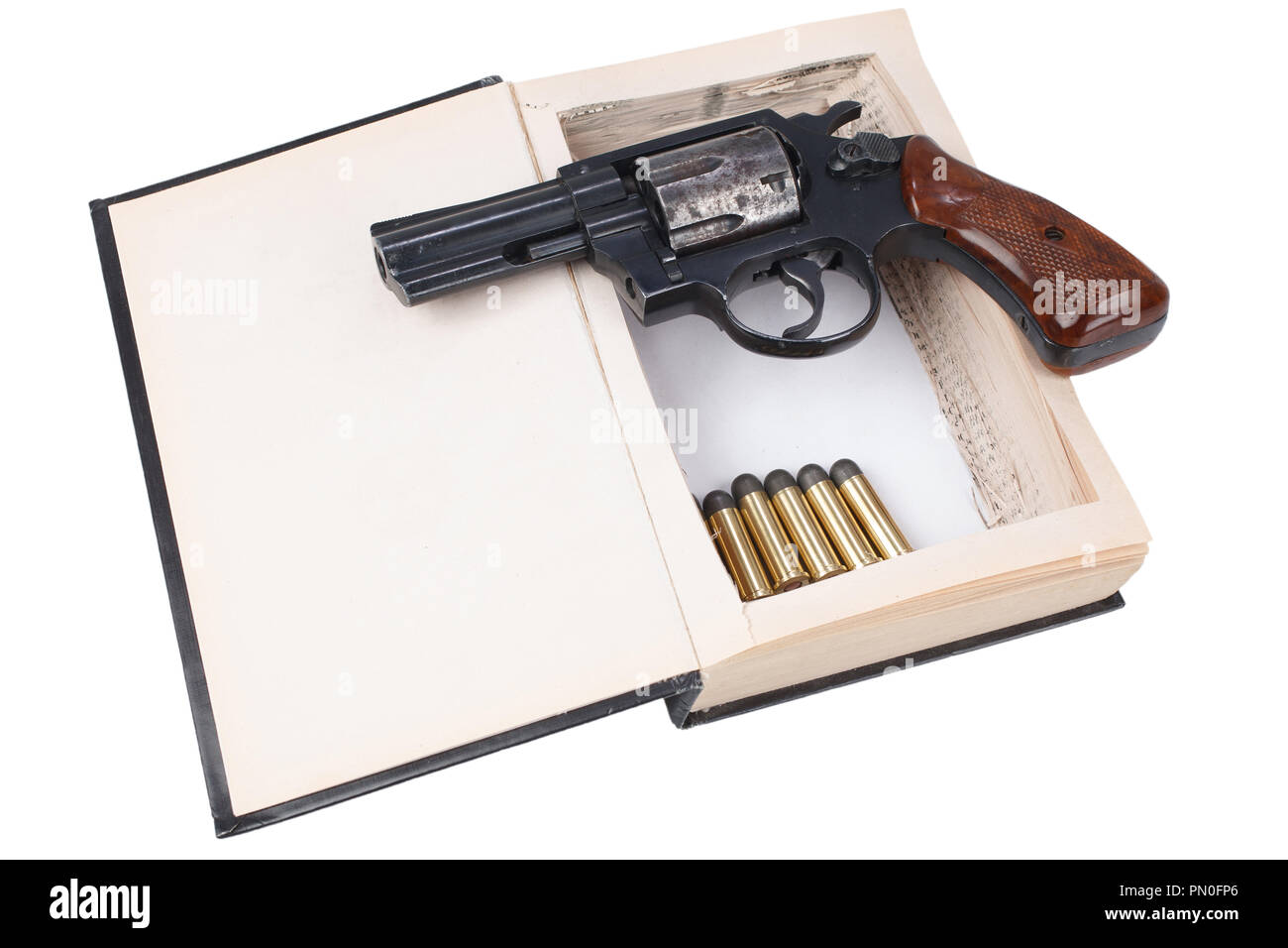 .38 caliber revolver gun with cartridges hidden in a book isolated on ...