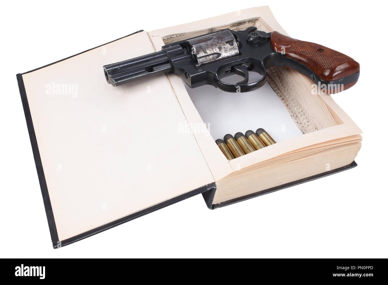 .38 caliber revolver gun with cartridges hidden in a book isolated on ...