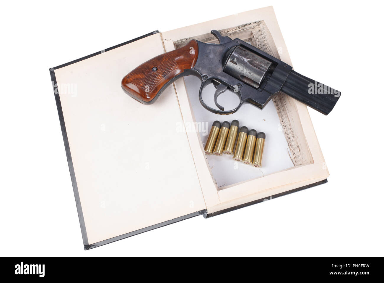 .38 caliber revolver gun with cartridges hidden in a book isolated on ...