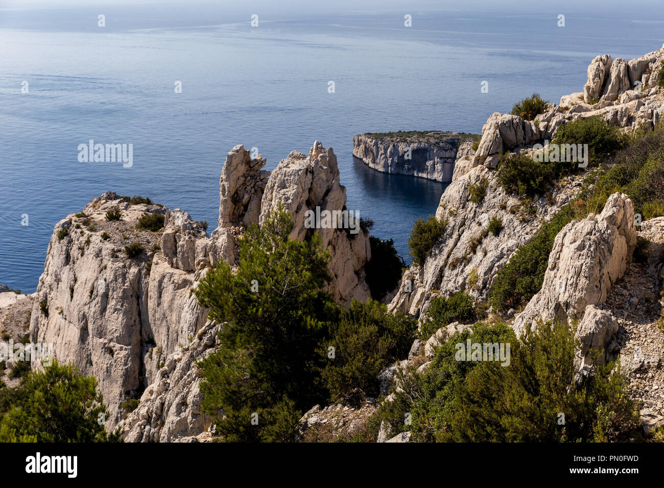 aerial view of high cliffs, green vegetation and calm sea in Calanques ...