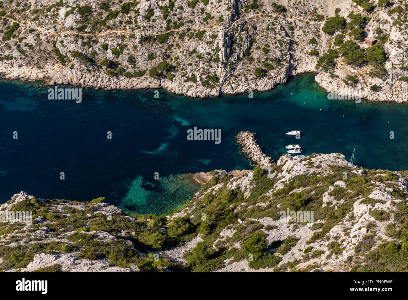 aerial view of boats in harbour and beautiful rocky mountains in ...