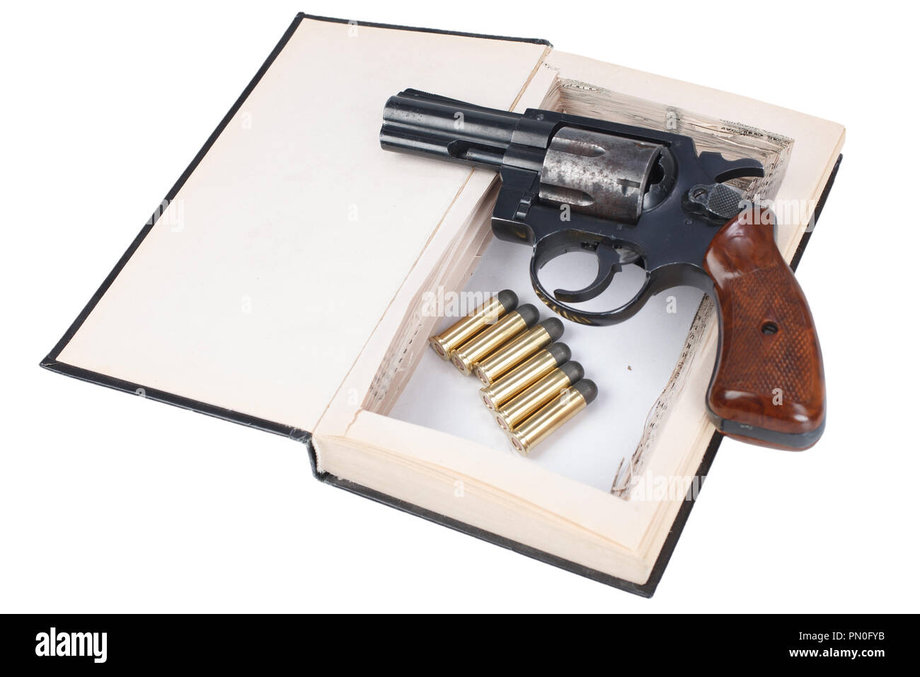 .38 caliber revolver gun with cartridges hidden in a book isolated on ...