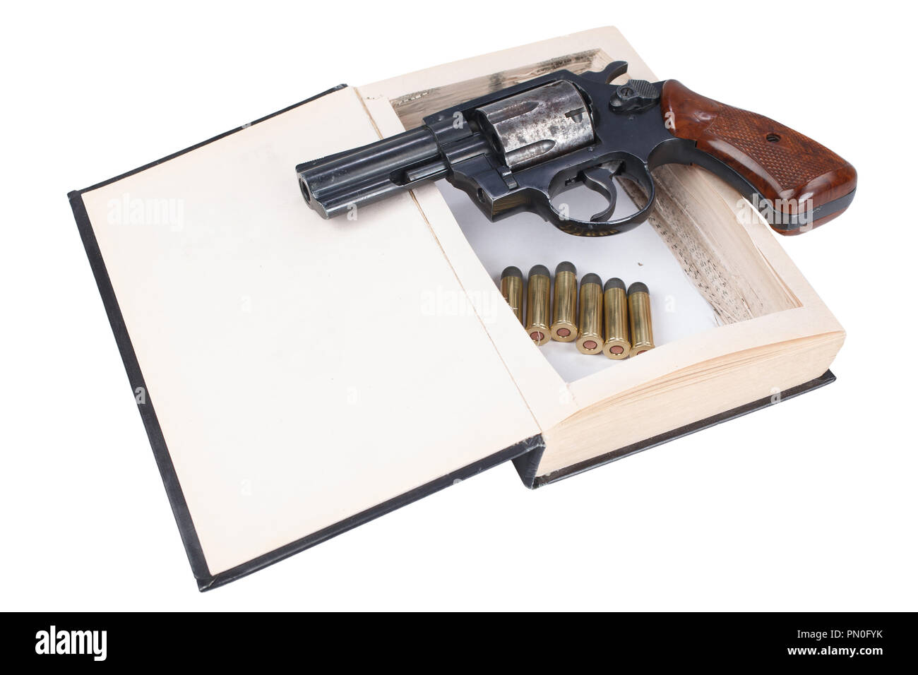 .38 caliber revolver gun with cartridges hidden in a book isolated on ...