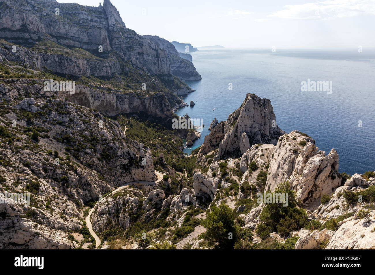 aerial view of winding road, cliffs and calm sea in Calanques de ...